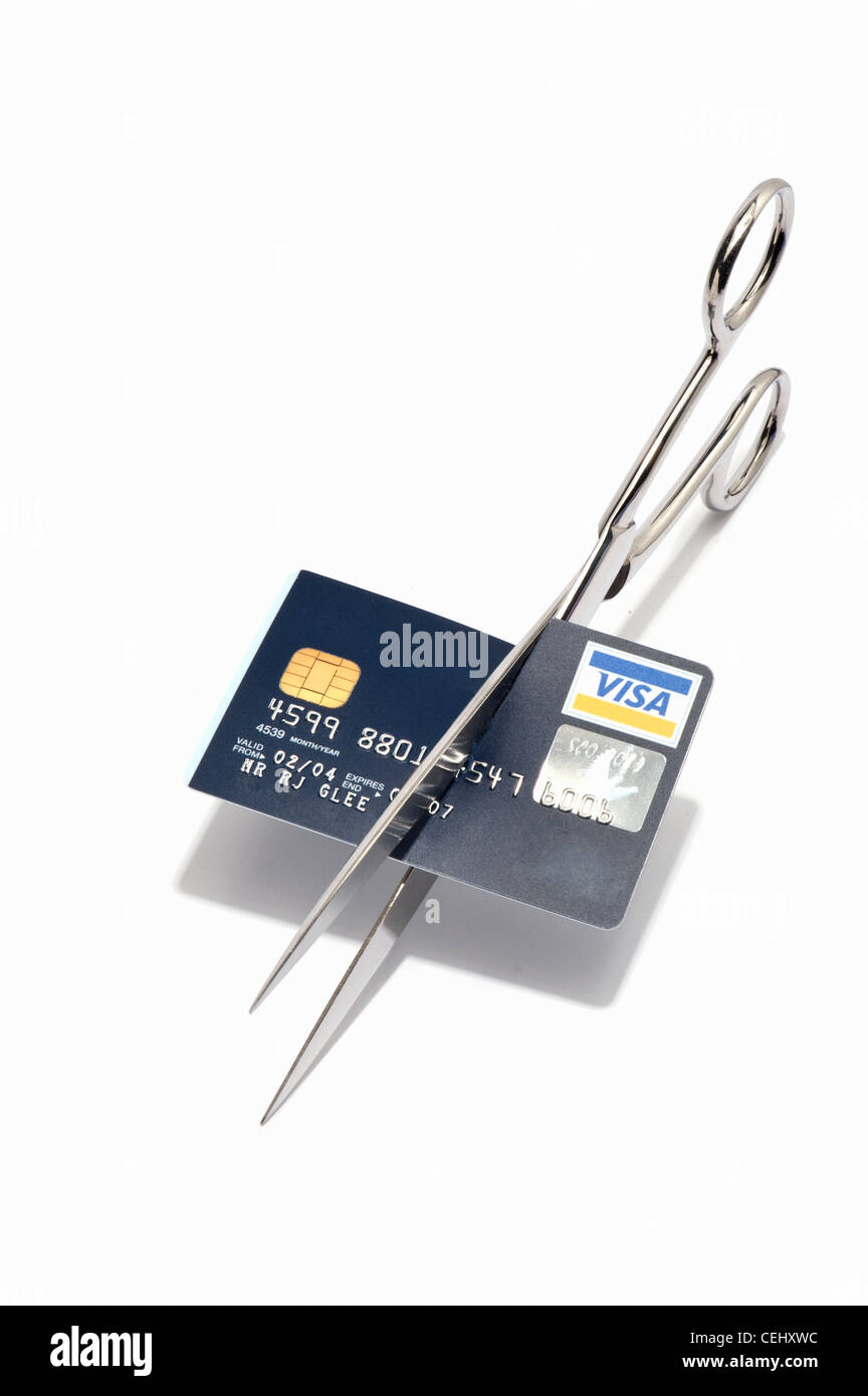 Scissors cutting up a visa credit card Stock Photo - Alamy