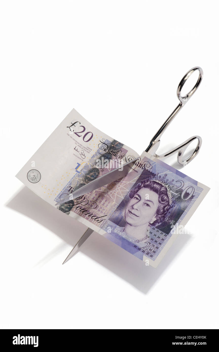 Scissors cutting up a 20 pound banknote Stock Photo - Alamy