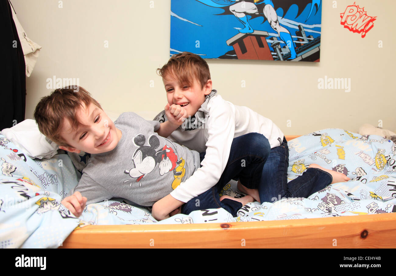 2 brothers fighting on a bed Stock Photo - Alamy