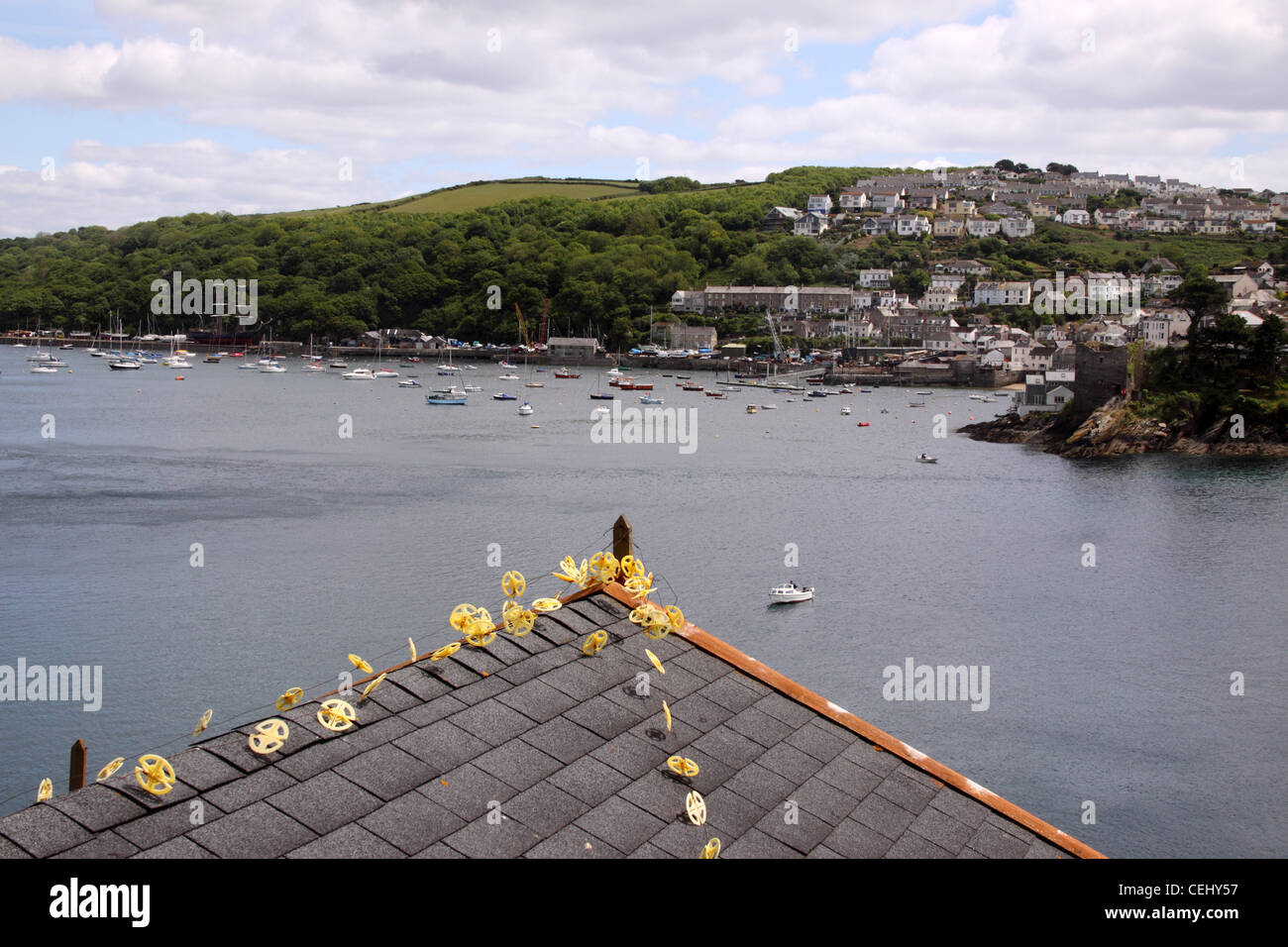 A seagull deterrent on a rooftop at Fowey, looking out over the river ...