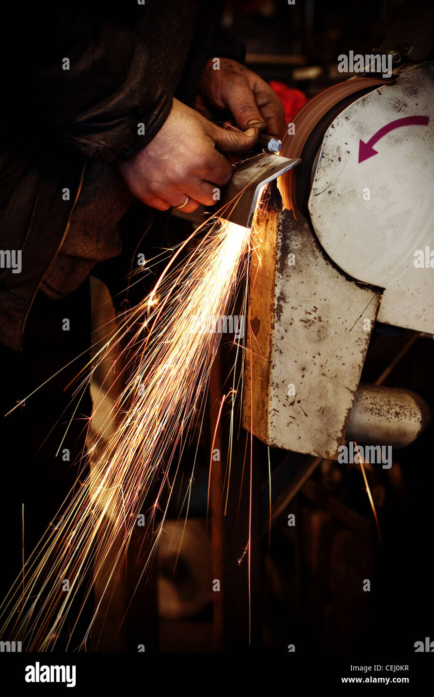 Worker grinding a metal plate Stock Photo - Alamy