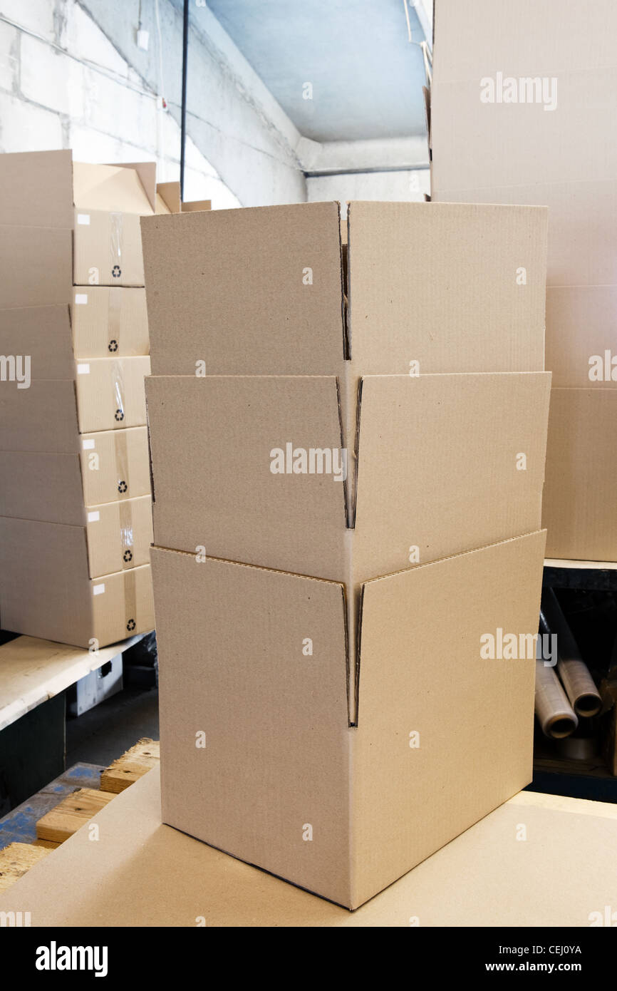 A lot of various cardboard boxes arranged up in stacks at an industrial ...