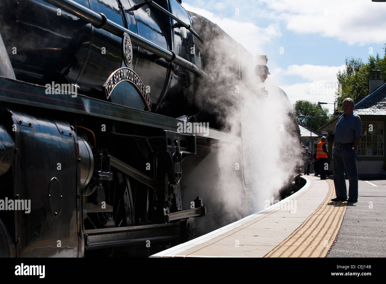 A steam train leaves the station in a cloud of steam on the Jacobite ...