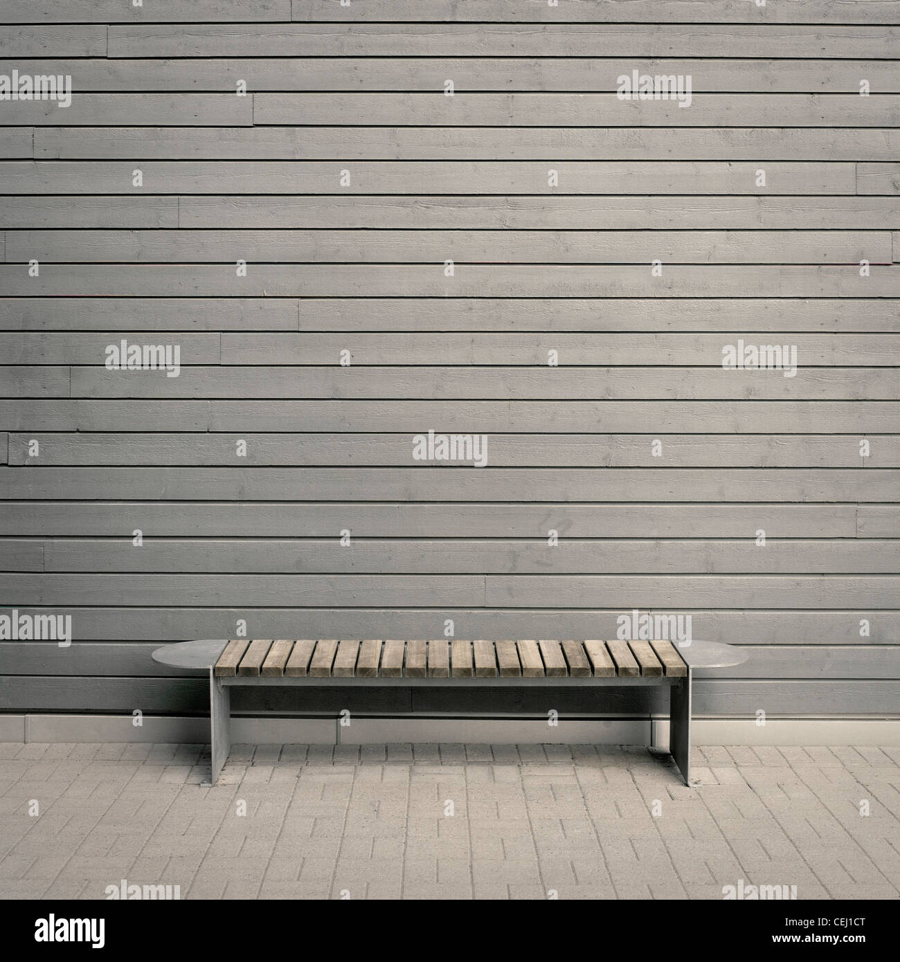 A bench in front of a wall Stock Photo - Alamy
