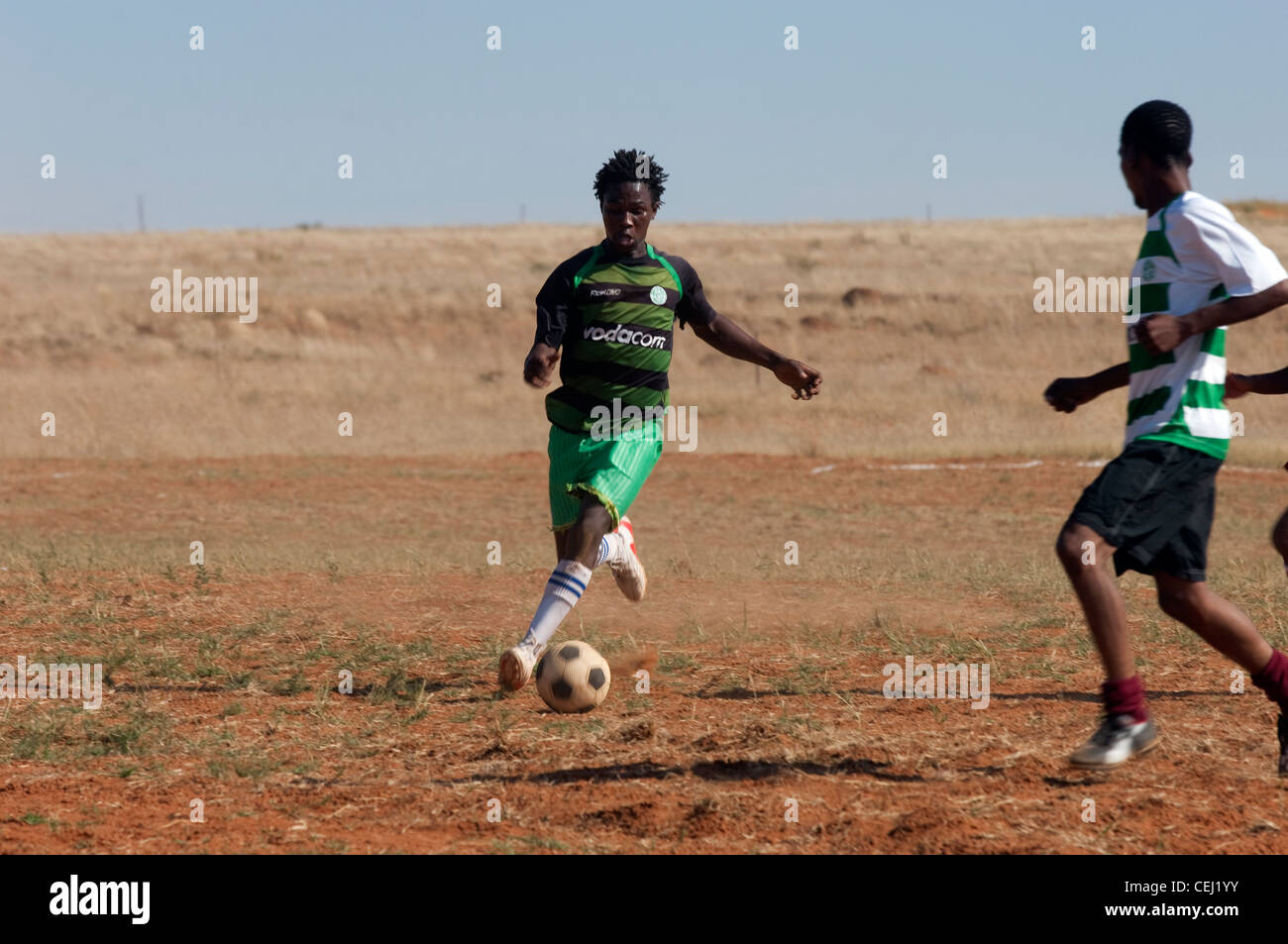 Soccer players on dusty rural field, outside Bloemfontein, Free State ...