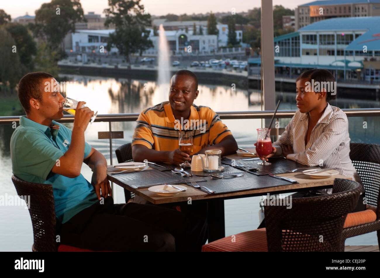 Tourists having sundowners at Cocos bar and restaurant at Loch Logan ...