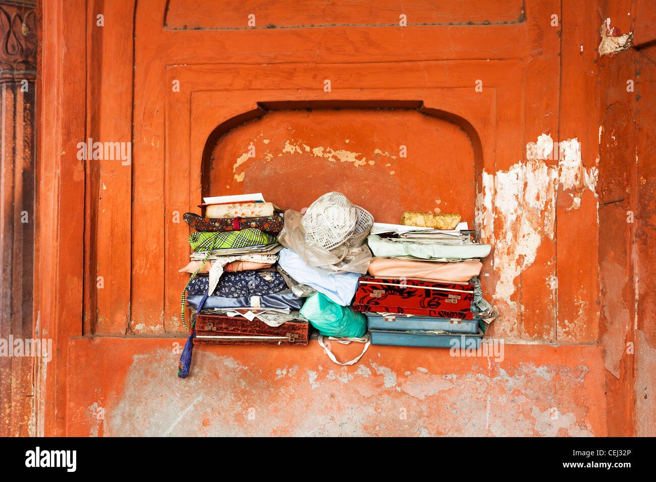 Scarves and cloths wrapping copies of the Koran in terracotta colored ...