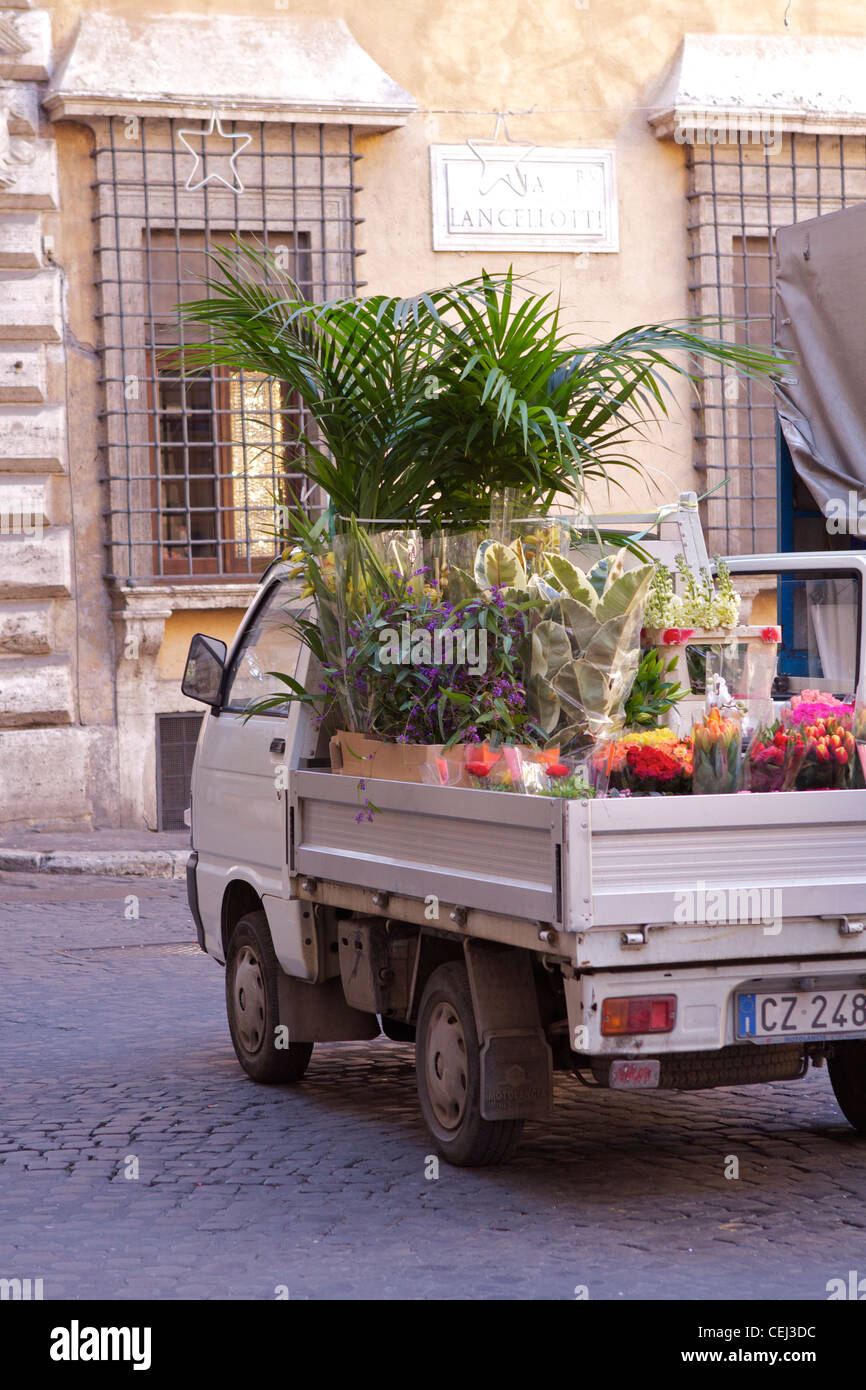 A small florist van transporting colourful flowers and plants, parked ...