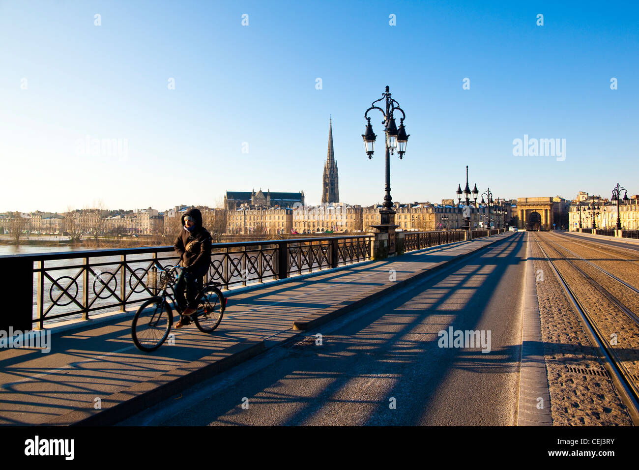 Pont de Pierre bridge crossing La Garonne River, with St Michel Tower ...