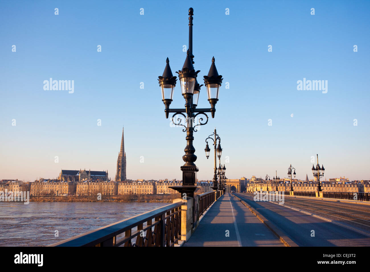 Pont de Pierre bridge crossing La Garonne River, with St Michel Tower ...