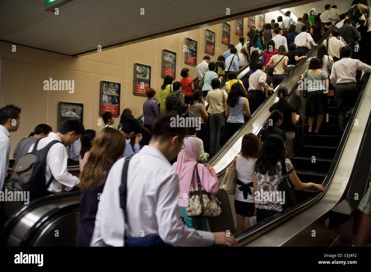 Commuters ride escalators in an Mass Rapid Transit, or MRT, station in ...
