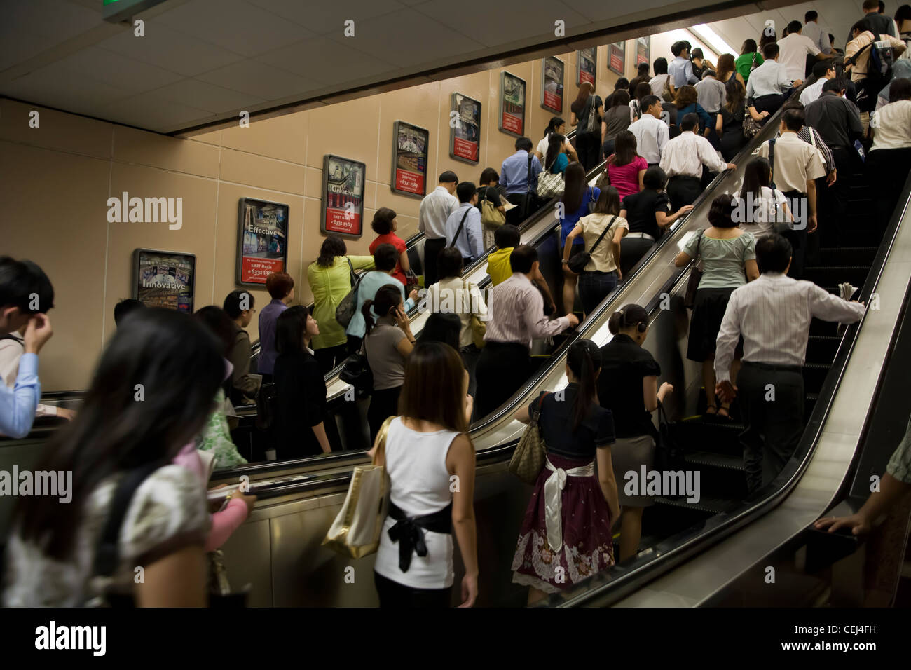 Commuters ride escalators in an Mass Rapid Transit, or MRT, station in ...