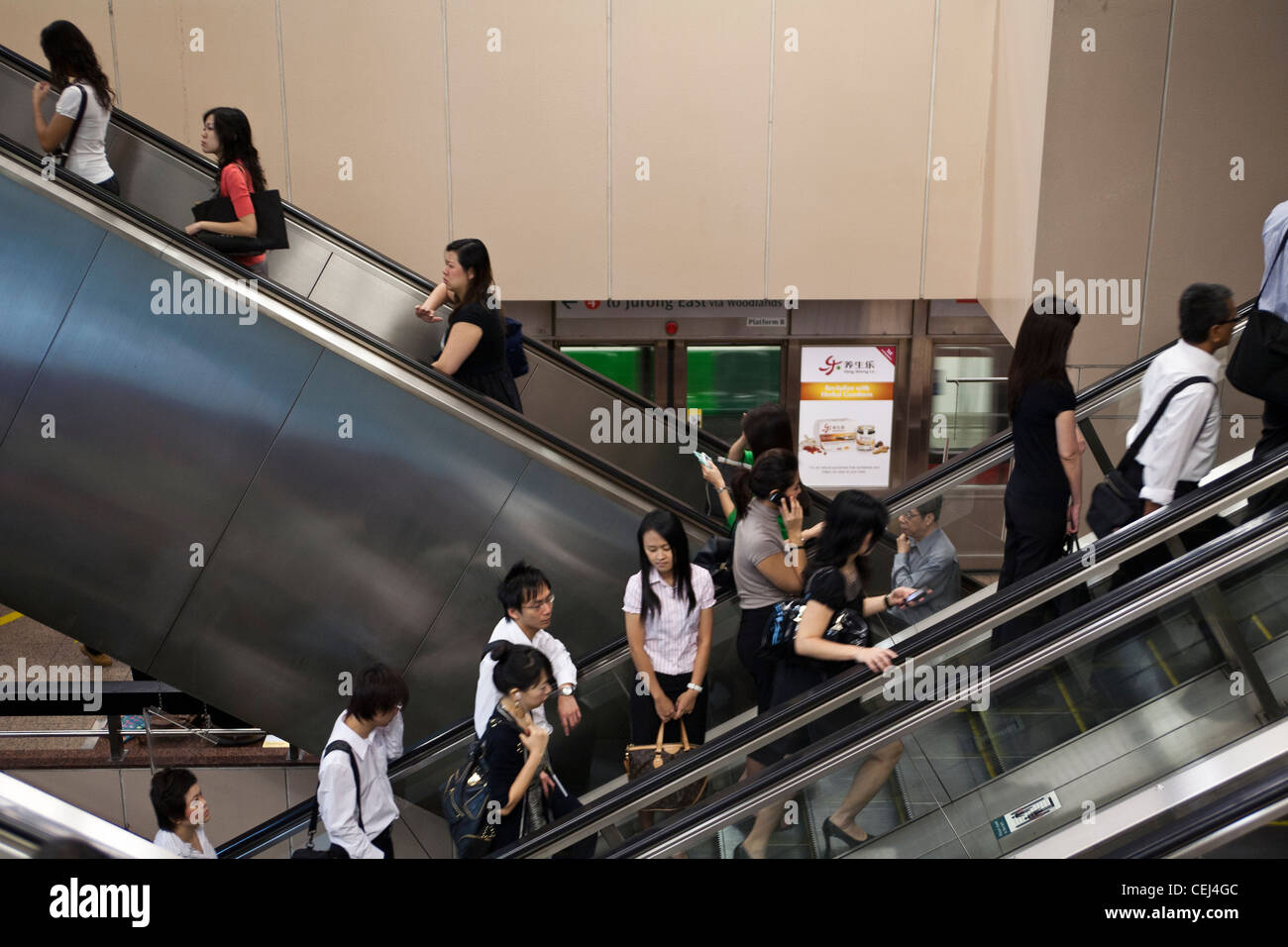 Commuters ride escalators in an Mass Rapid Transit, or MRT, station in ...