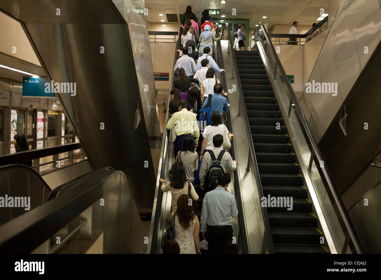 Commuters ride escalators in an Mass Rapid Transit, or MRT, station in ...