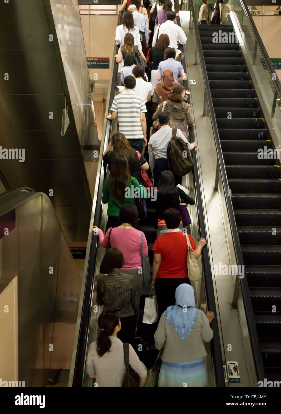 Commuters ride escalators in an Mass Rapid Transit, or MRT, station in ...