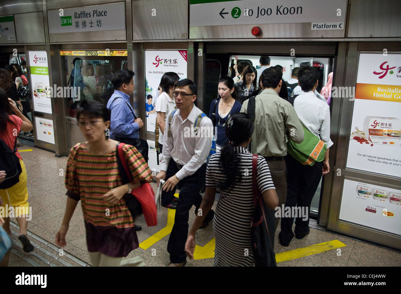 Commuters get off a Mass Rapid Transit, or MRT, train in the central ...