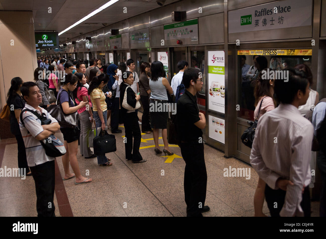 Commuters get off a Mass Rapid Transit, or MRT, train in the central ...