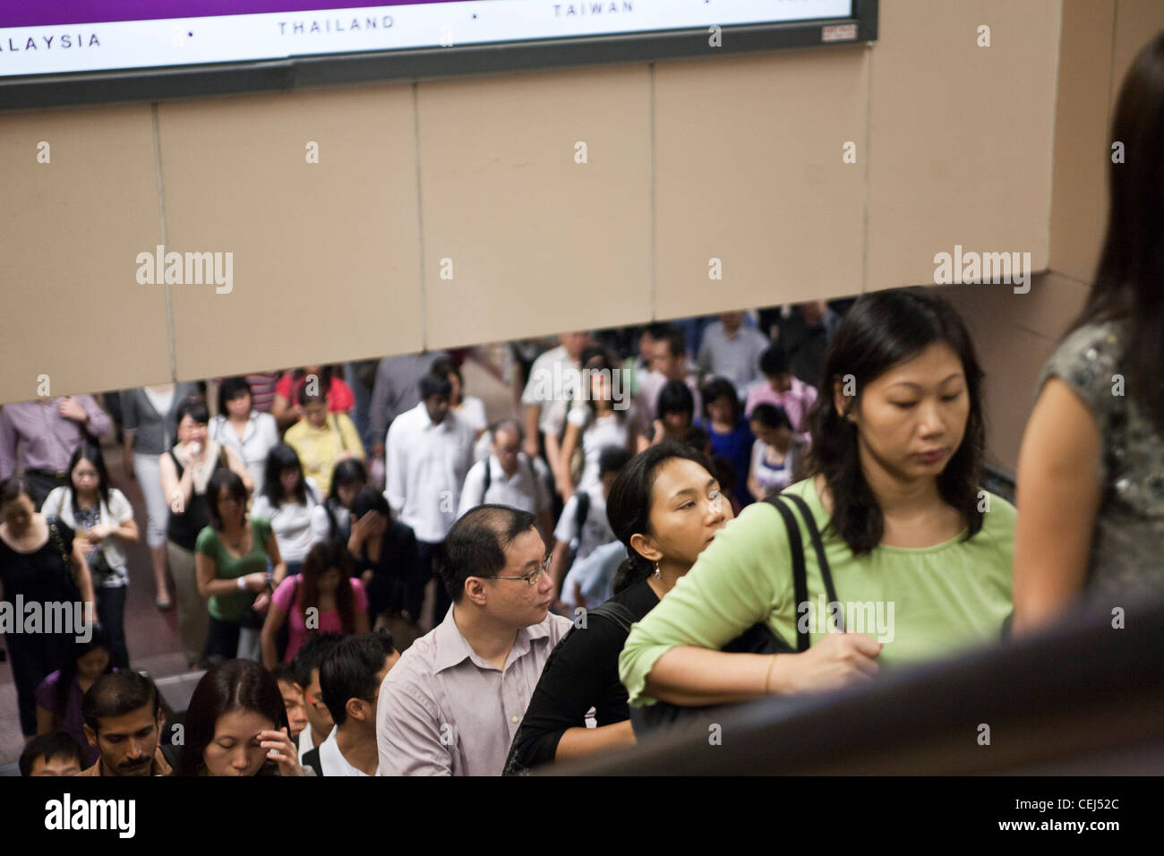 Commuters ride escalators in an Mass Rapid Transit, or MRT, station in ...