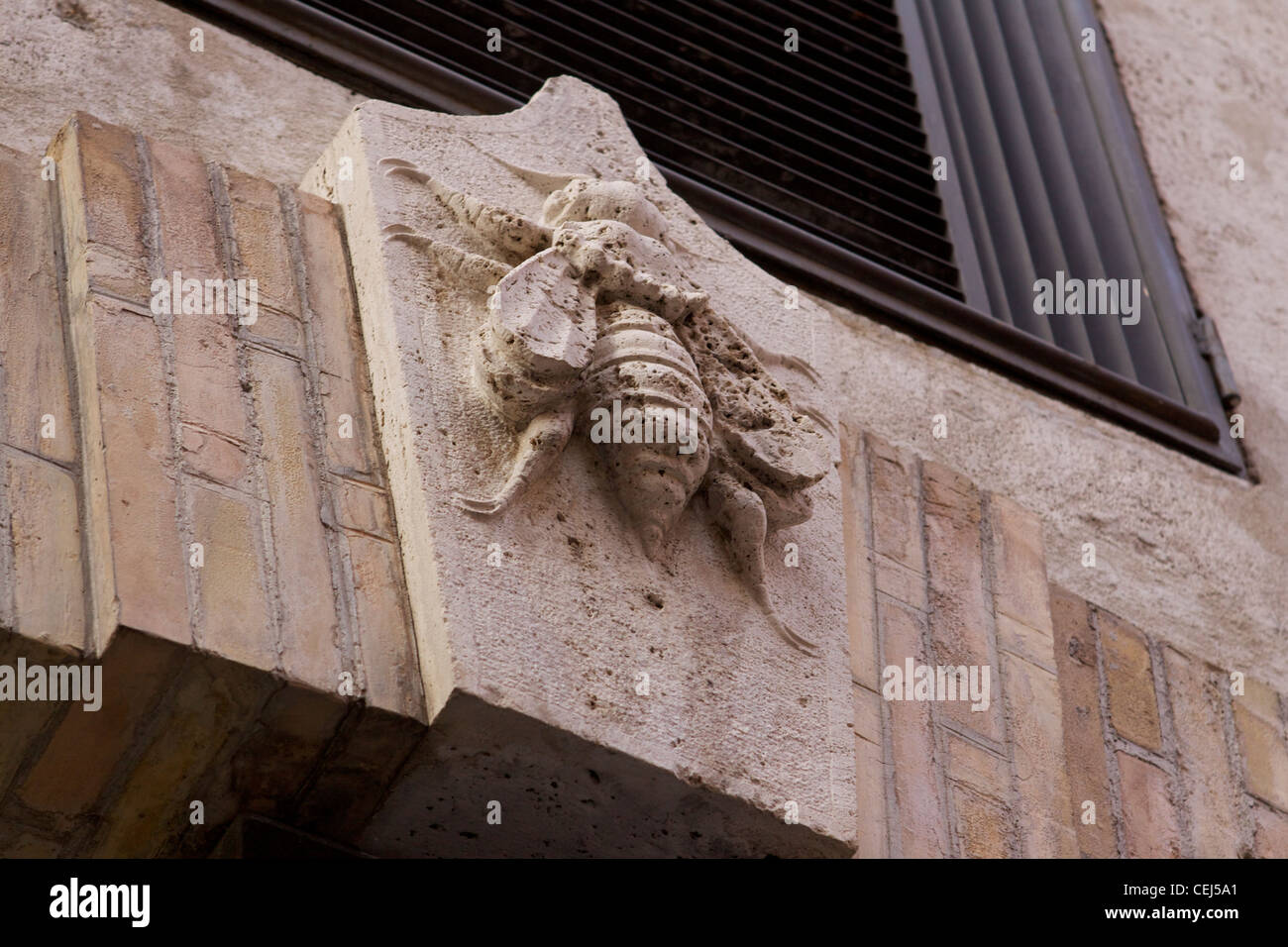 A carved stone heraldic bee, symbol of the Barberini family above a ...