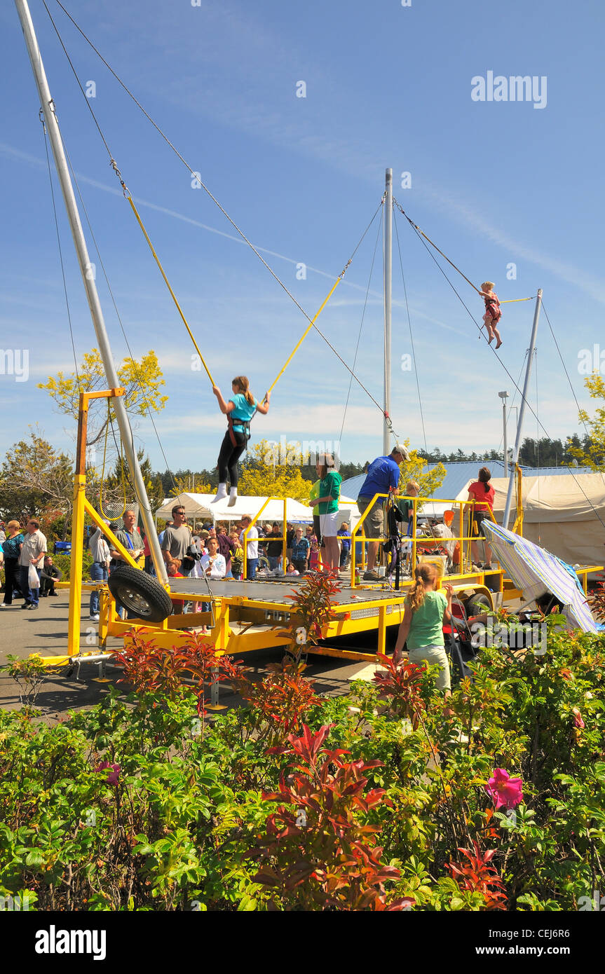 Bungee jumping ride at a carnival. People having fun Stock Photo - Alamy