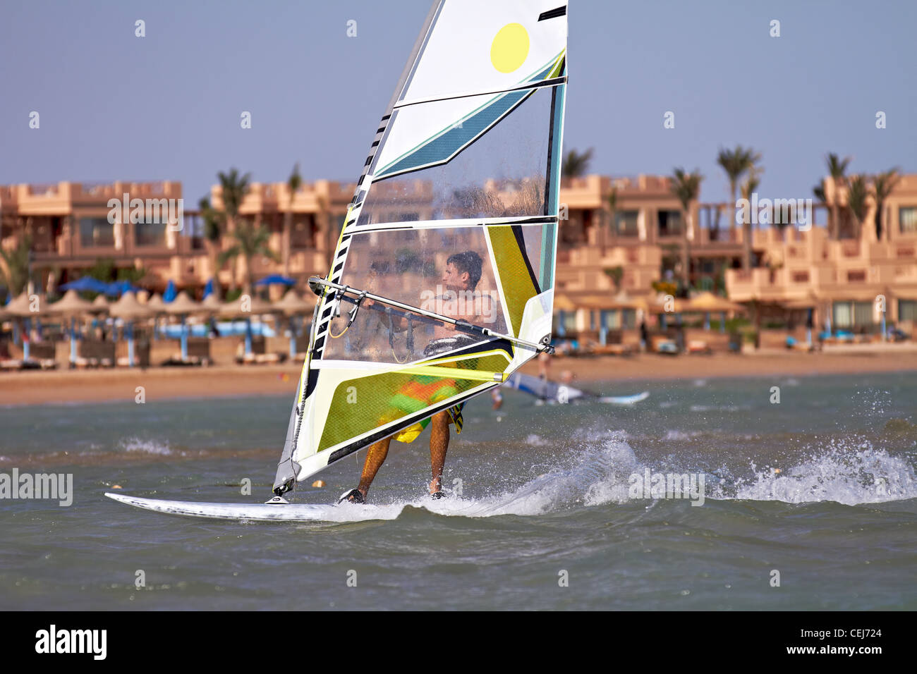 Young man windsurfing with trailing wake Stock Photo - Alamy