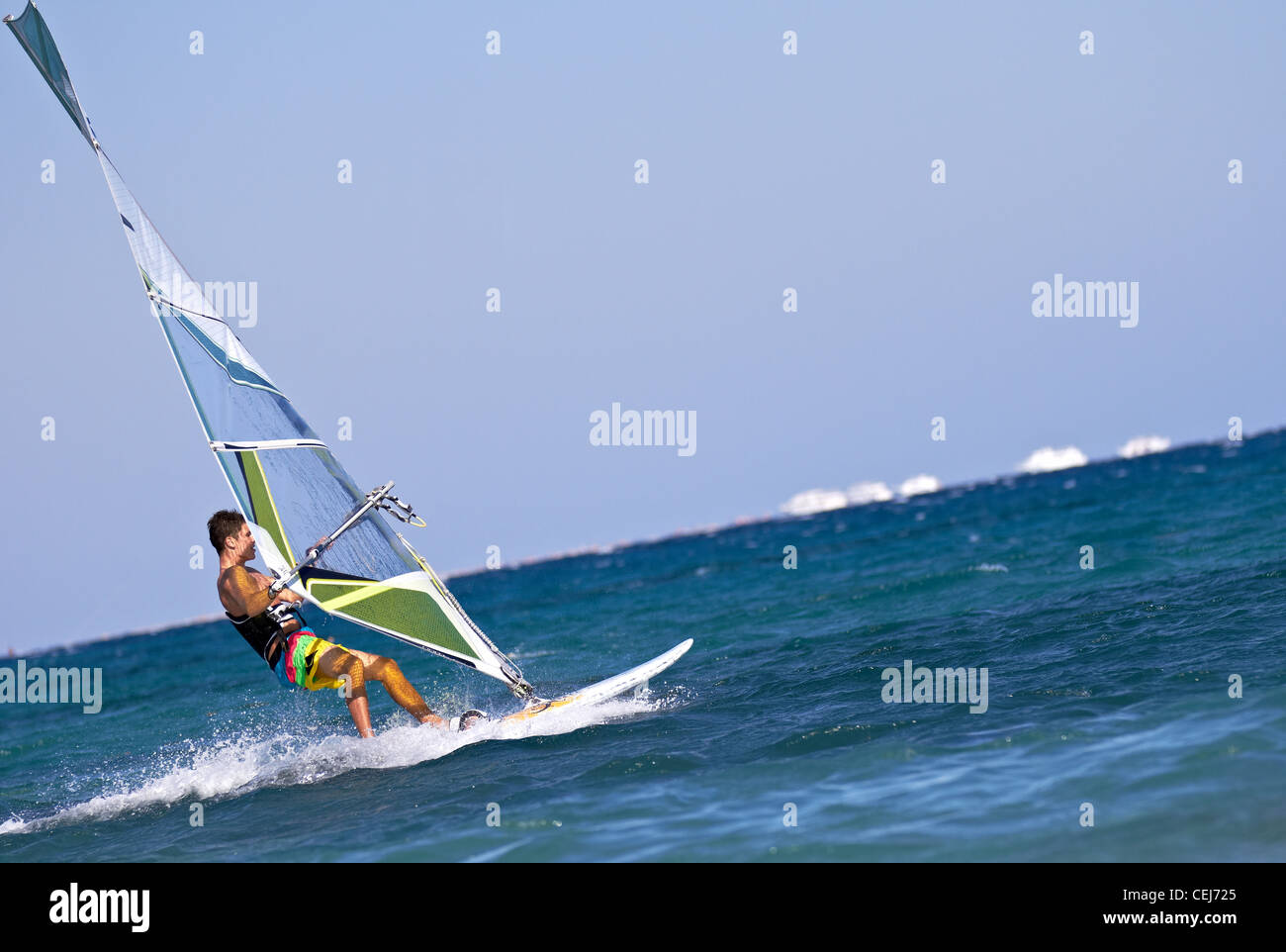 Young man windsurfing with trailing wake Stock Photo - Alamy