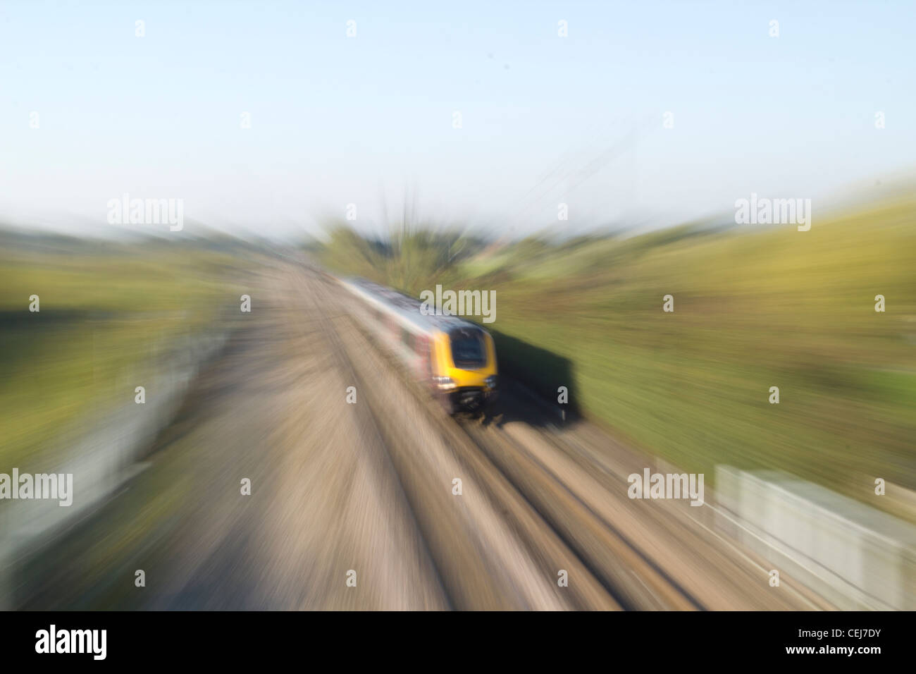 Emphasis of speed. Zoom back view of XC Voyager train, Stenson junction ...