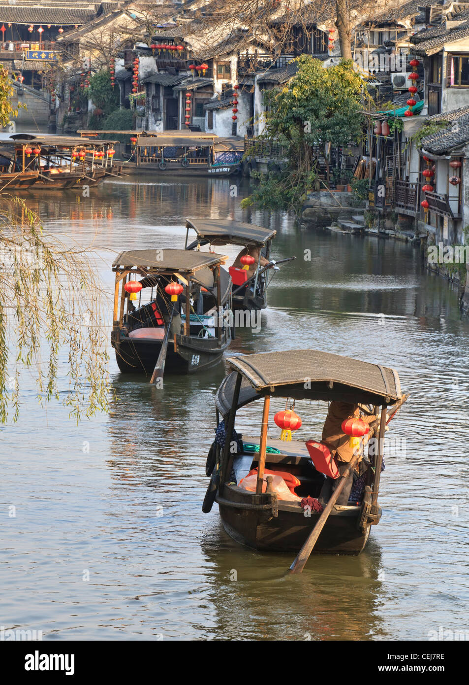 Boats carrying tourists on the waterway in the beautiful town of Xitang ...