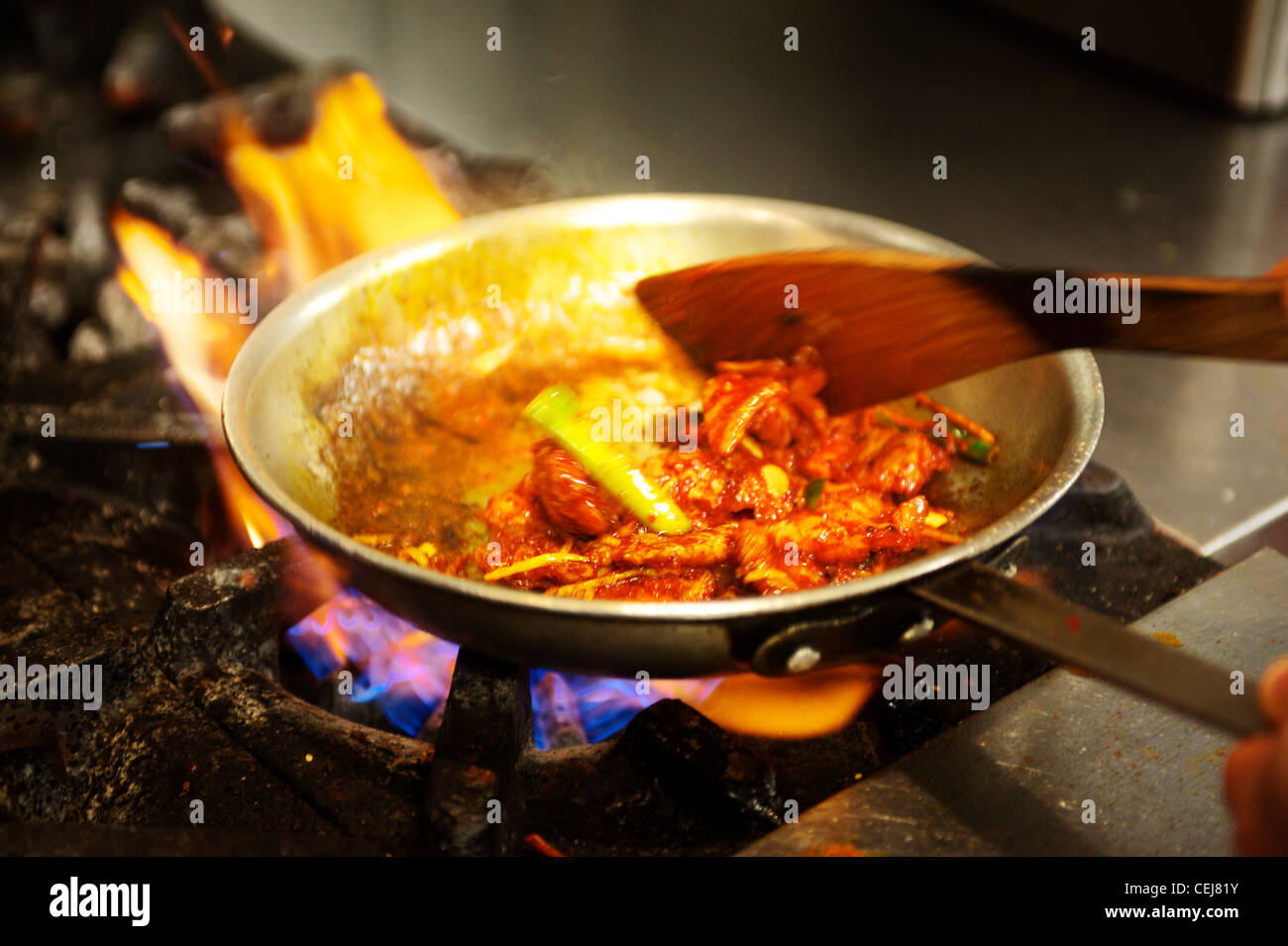 A chef stir frying at a Korean restaurant Stock Photo - Alamy