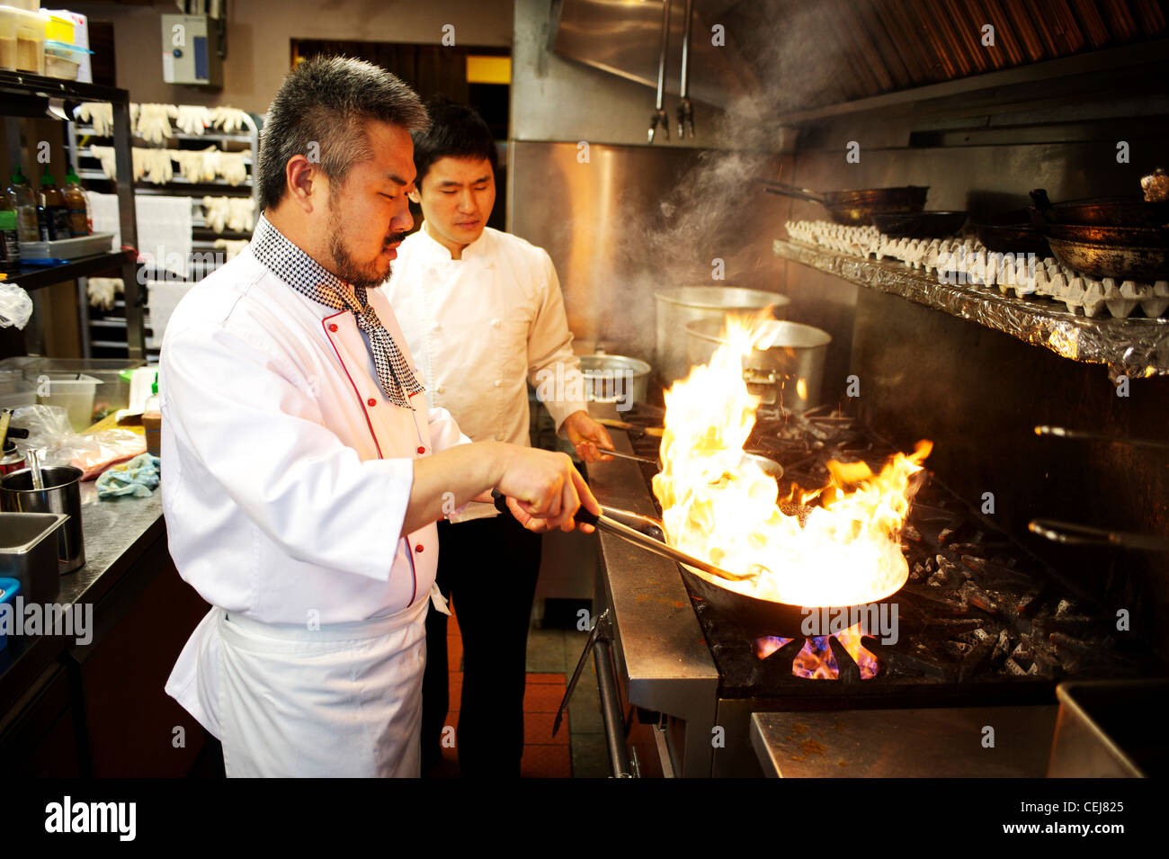 A chef stir frying with a wok, at a Korean restaurant Stock Photo - Alamy