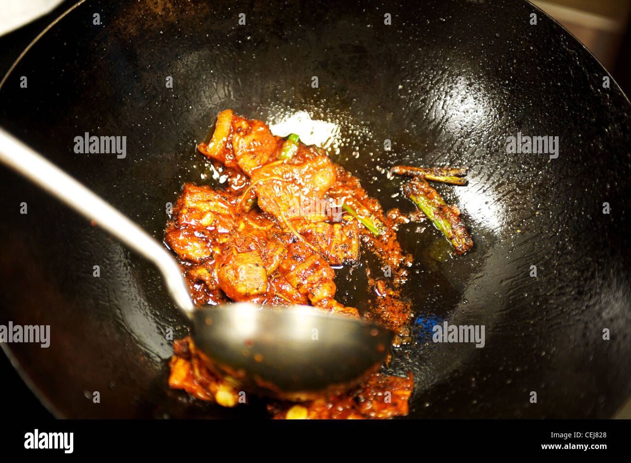A chef stir frying in a wok at a Korean restaurant Stock Photo - Alamy