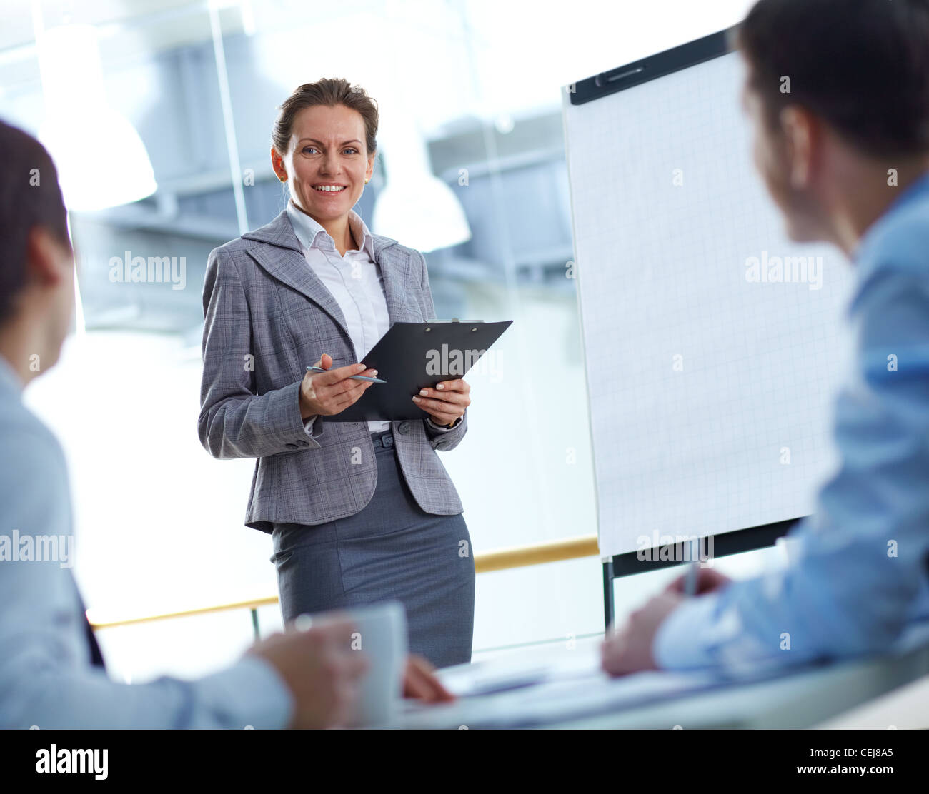 Business lady presenting a project to her colleagues Stock Photo - Alamy