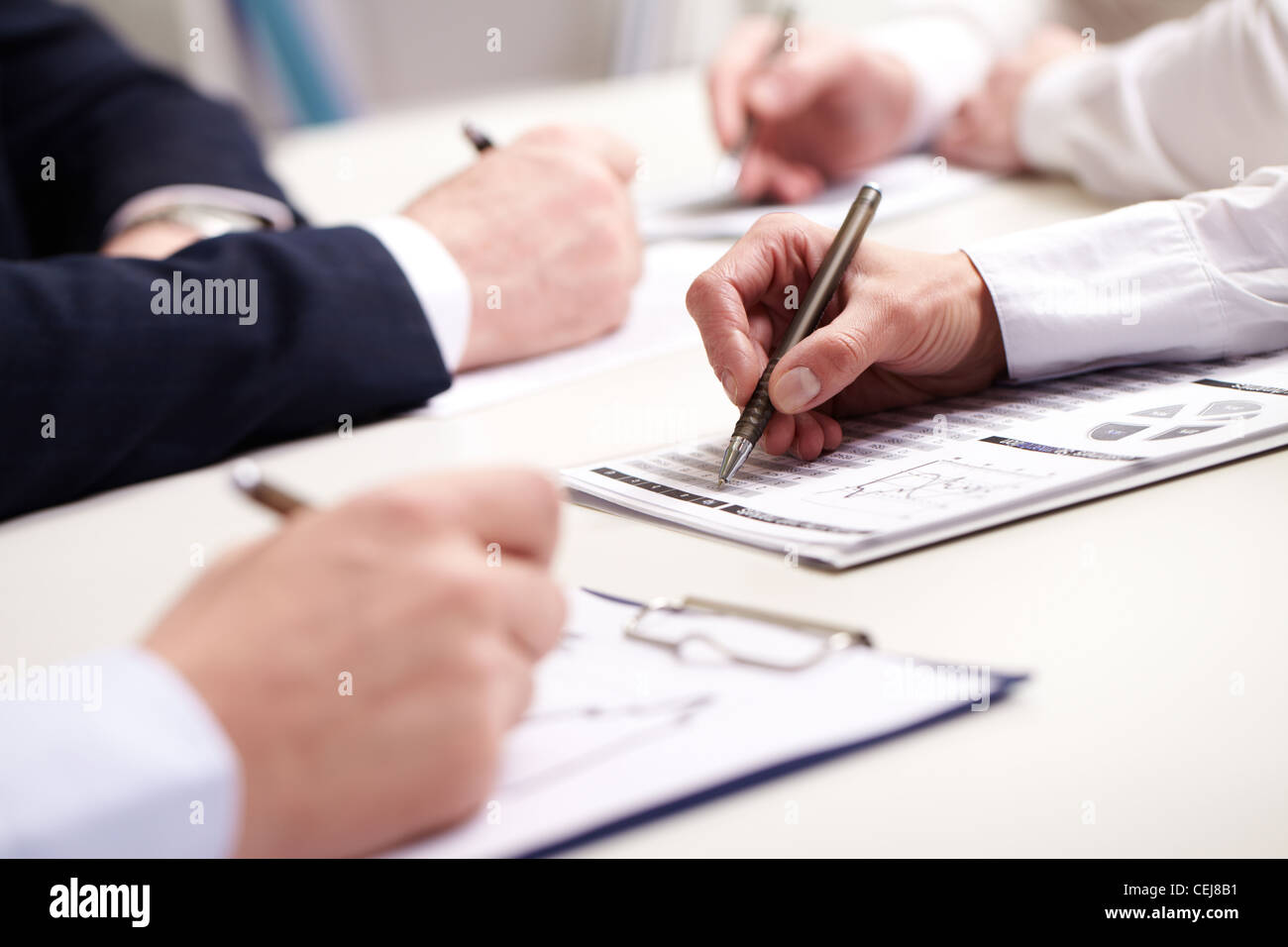 Business people taking notes at briefing Stock Photo - Alamy