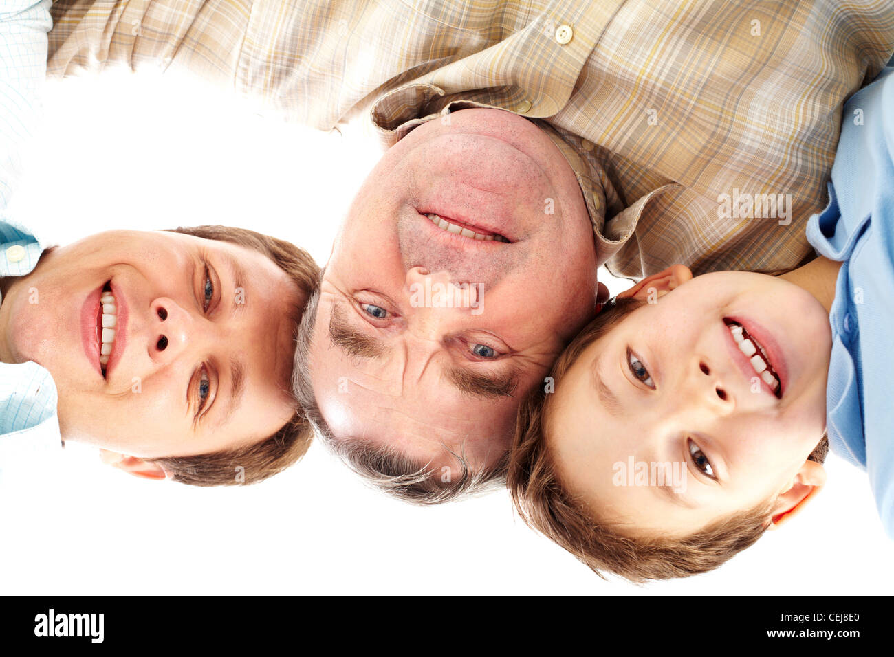 Multigenerational portrait of male members of the family smiling and ...