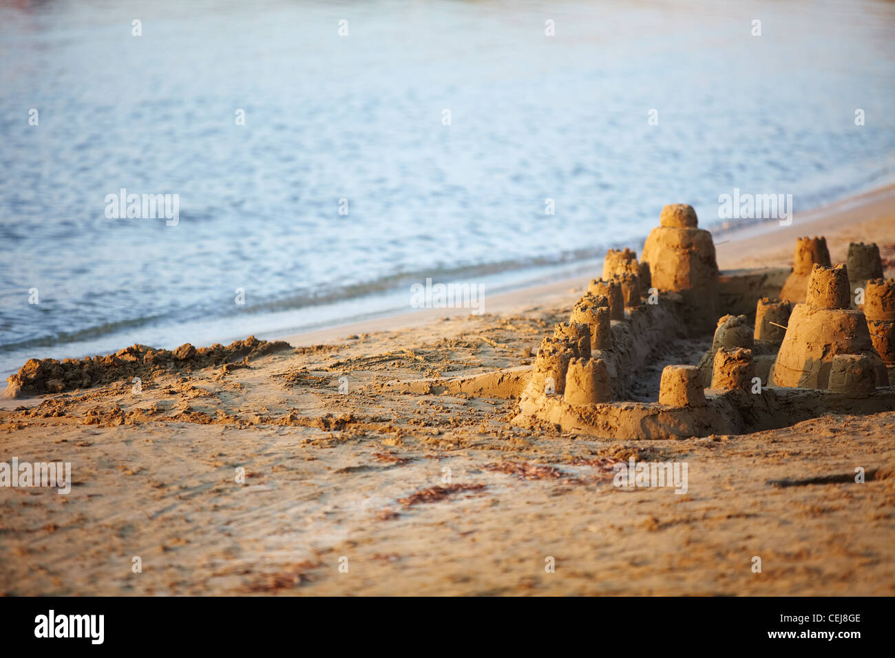 Sand castle on the beach at sunset Stock Photo - Alamy