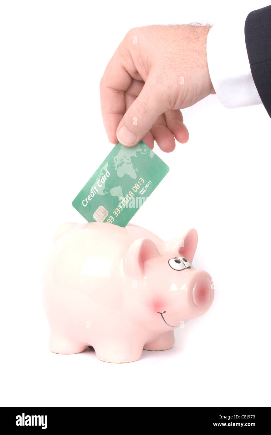 Piggy bank on white with a credit / debit card Stock Photo - Alamy
