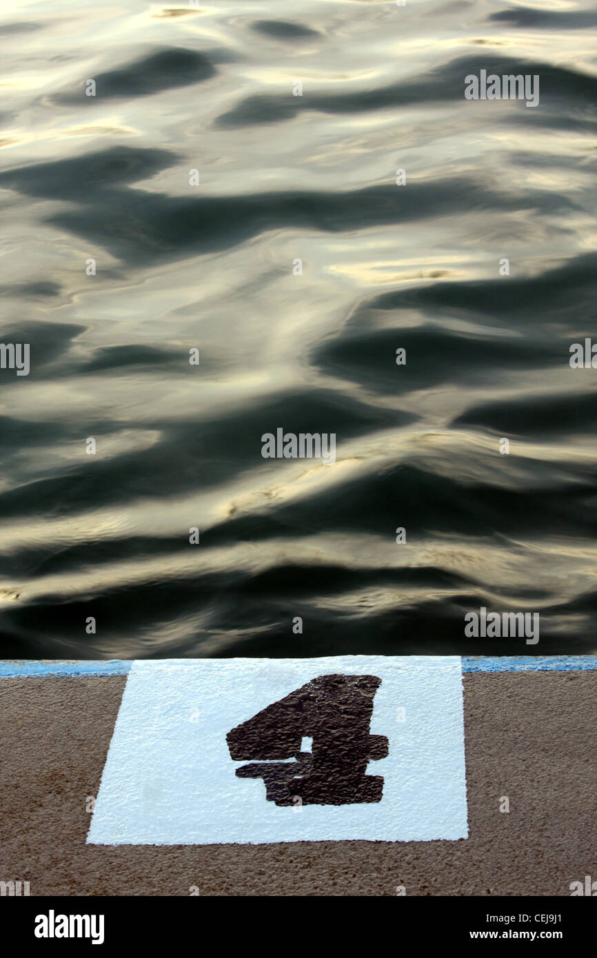 Number four 4 swimming pool lane Stock Photo - Alamy