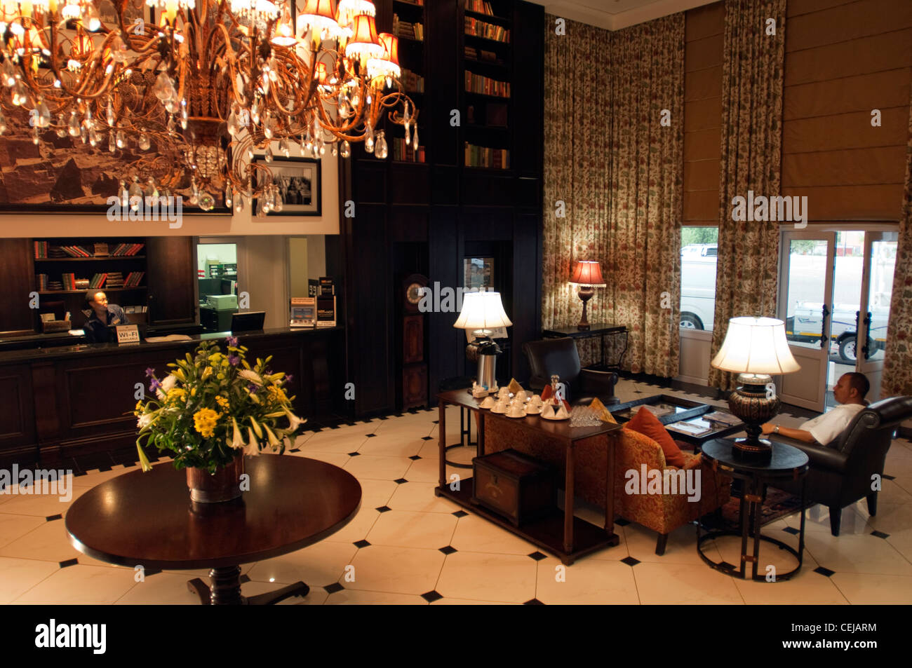 Man sitting in hotel foyer Stock Photo - Alamy