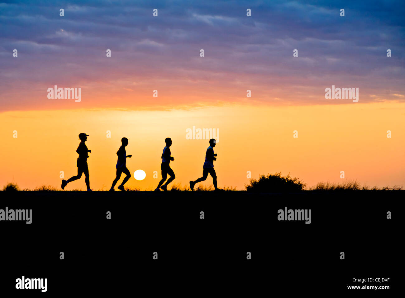 Four people running at sunrise, Ahal Province, Turkmenistan Stock Photo ...