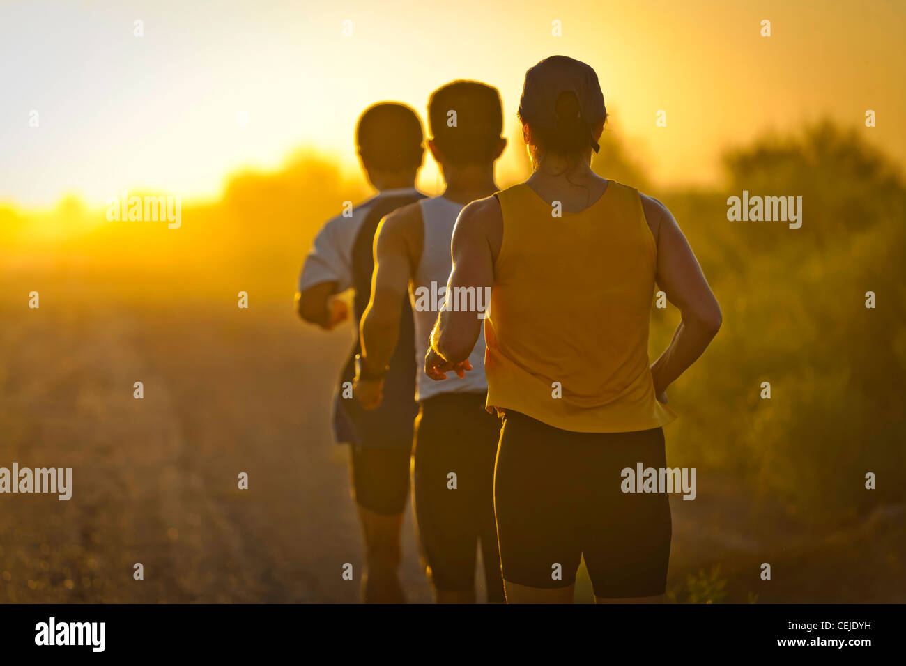 Three people running at sunrise, Ahal Province, Turkmenistan Stock ...