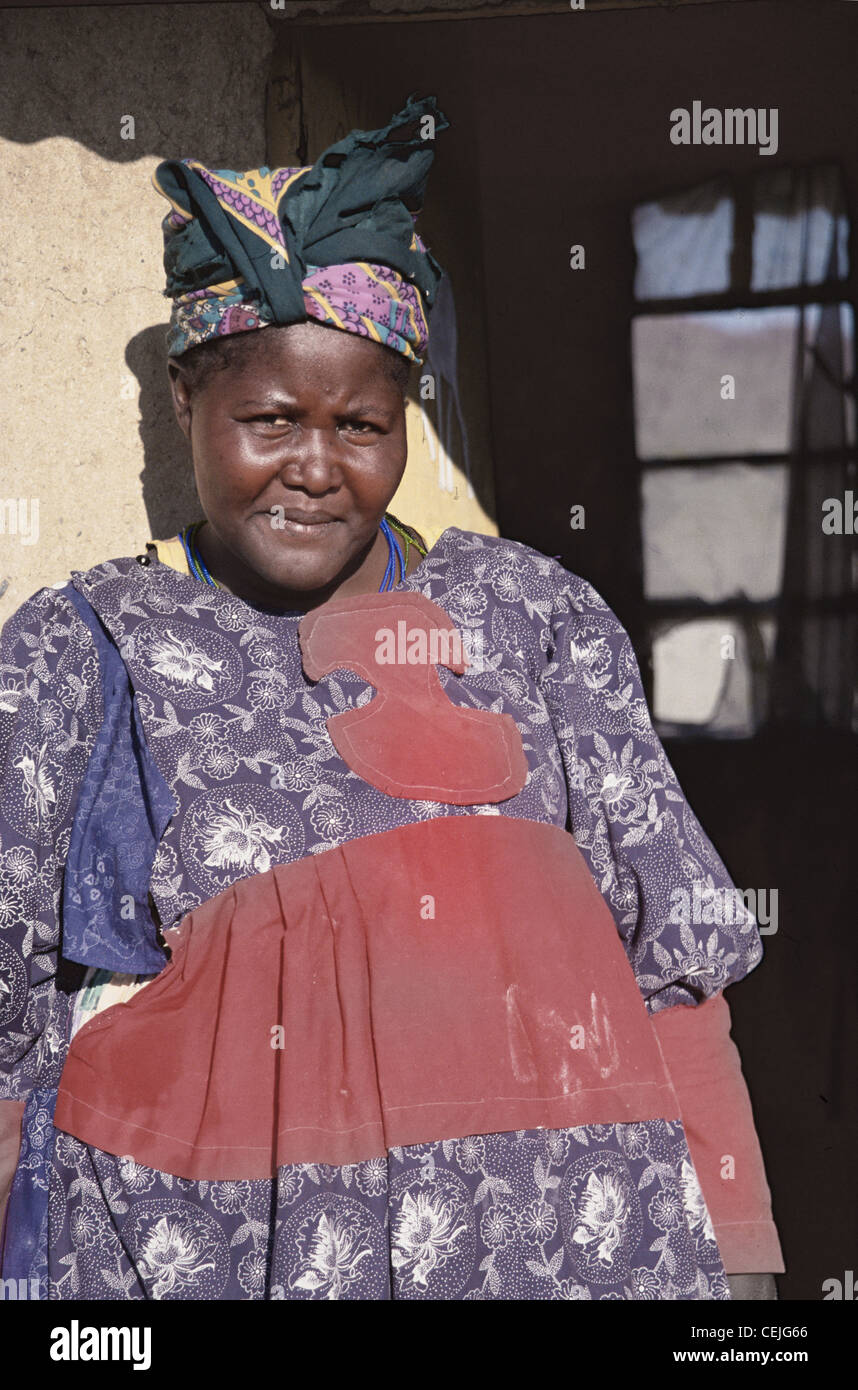Herero woman in her doorway in village of Purros, north-west Namibia ...