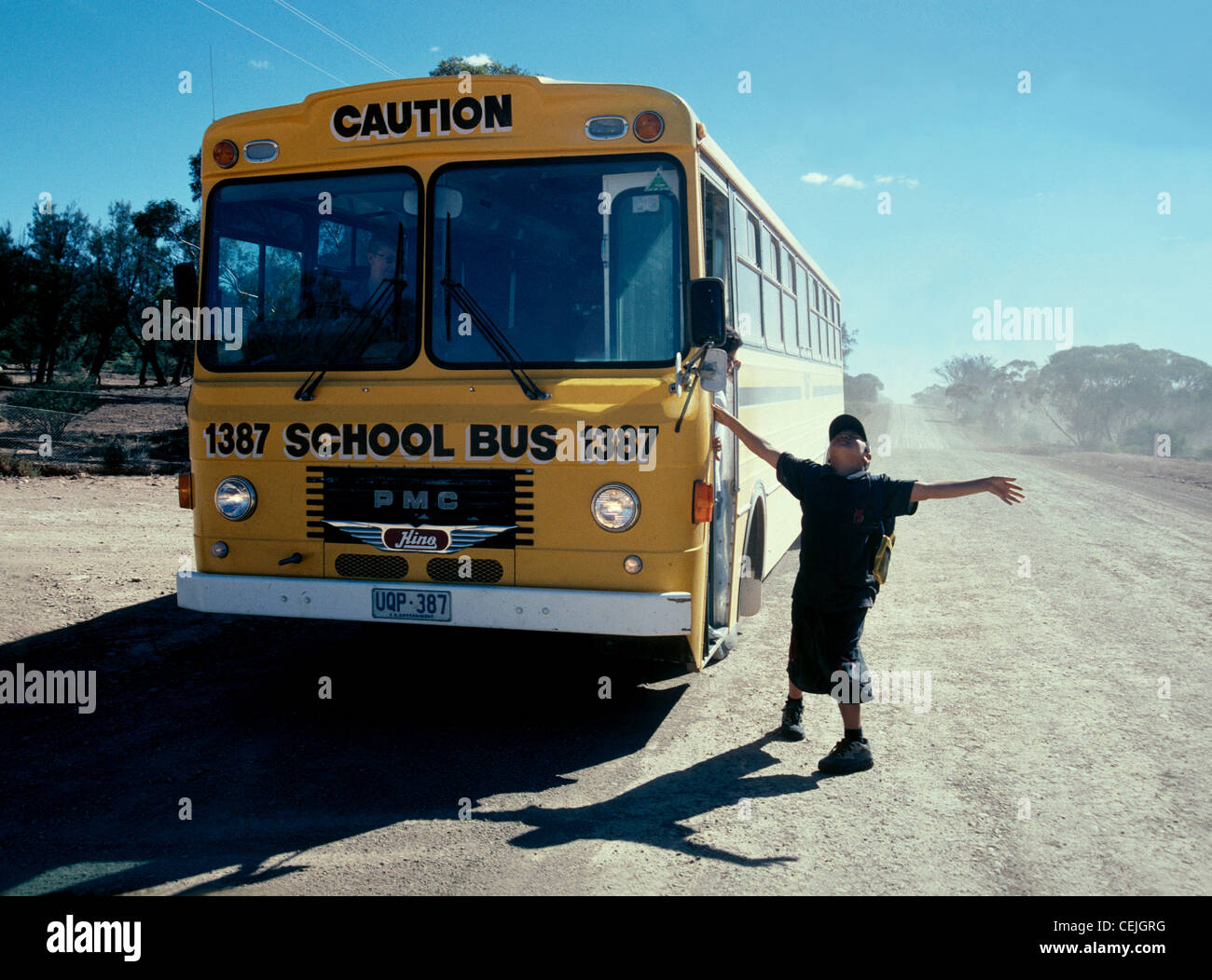 Boy elated to be returning home from school as he jumps off the school ...