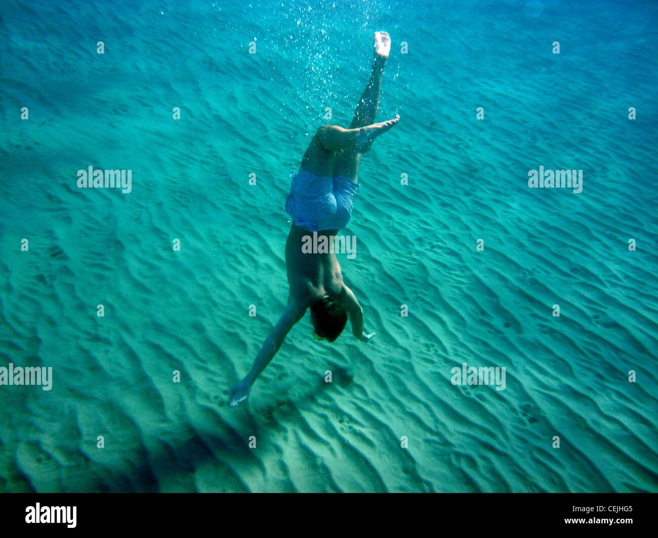 Swimmer underwater acrobatics on seabed Stock Photo - Alamy