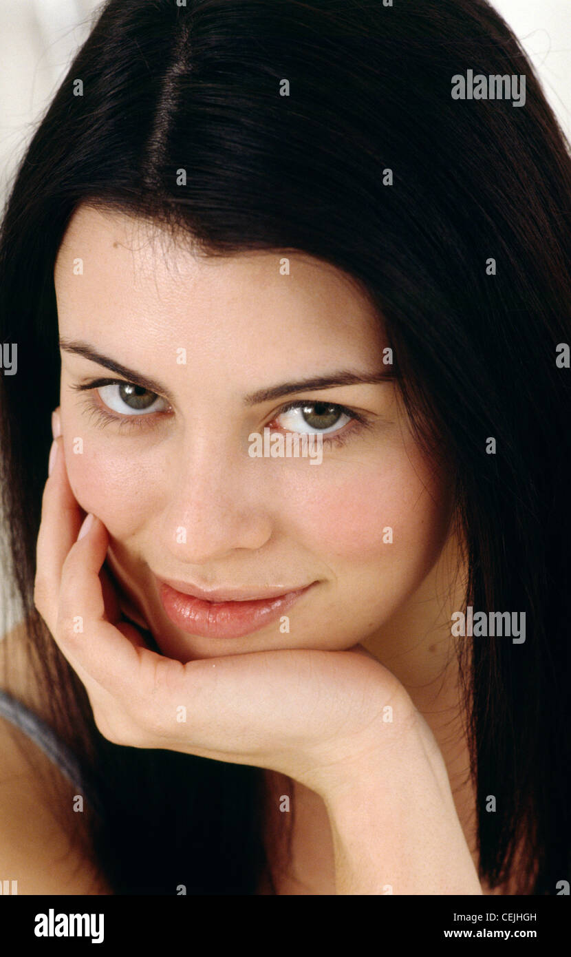 Female with brunette hair framing face, wearing natural make up, chin ...