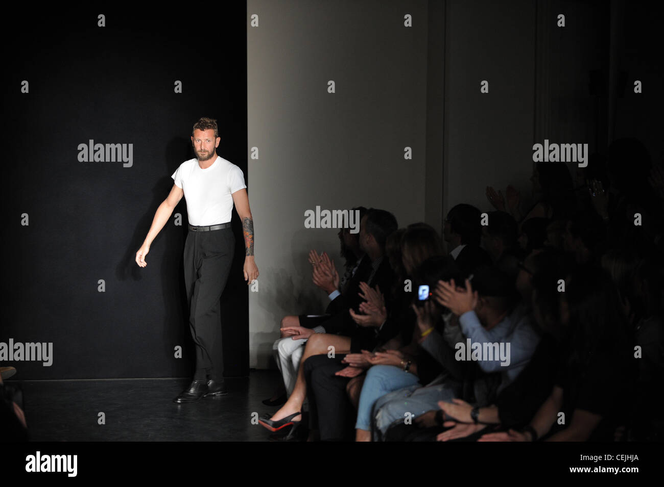 Fashion designer Stefano Pilati wearing a white t shirt and black ...