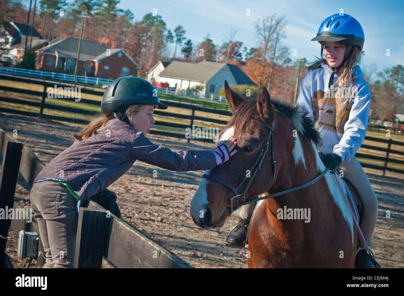 Young girls take horseback riding lessons Stock Photo - Alamy
