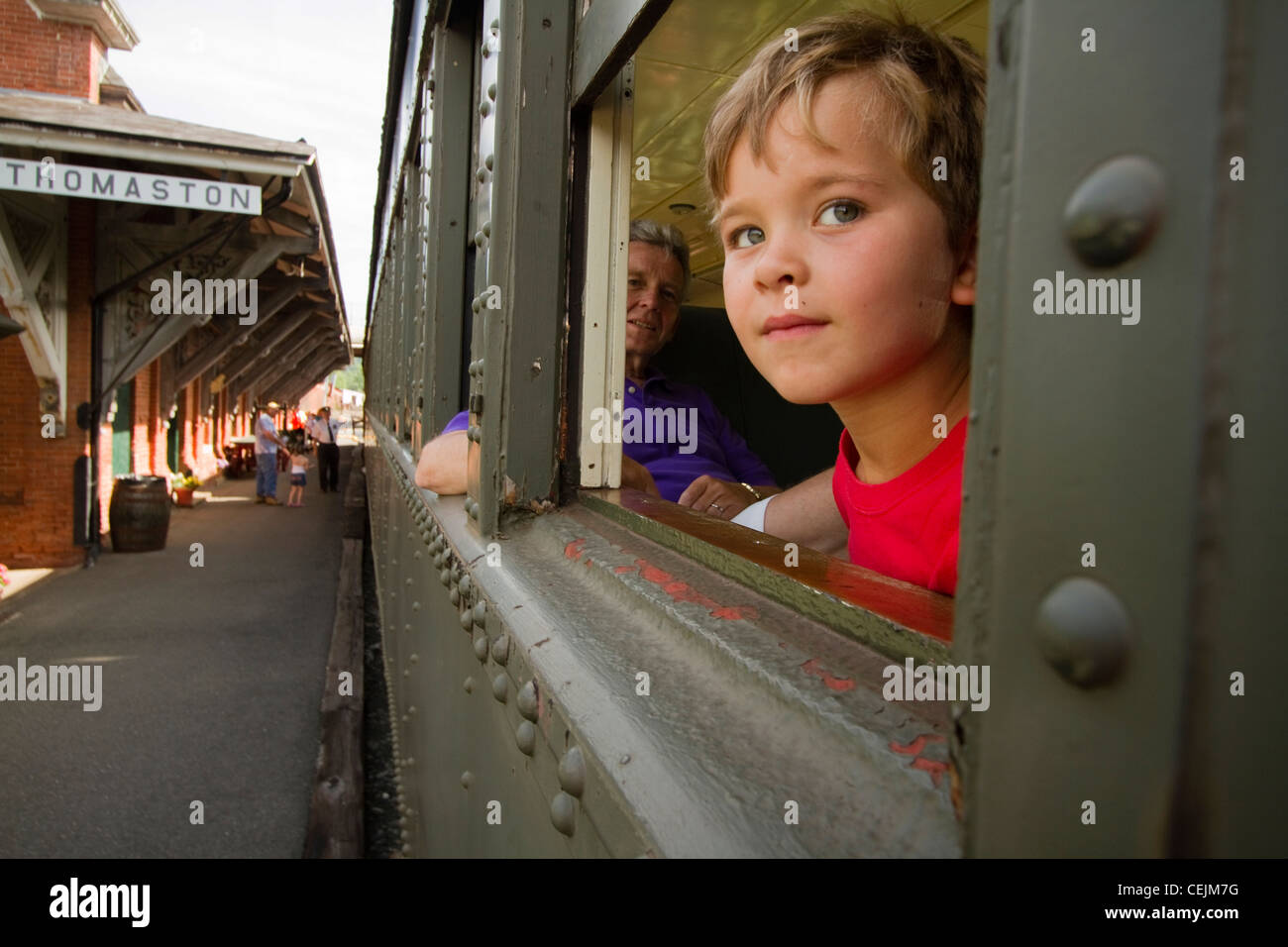 A child looking out a train window Stock Photo - Alamy