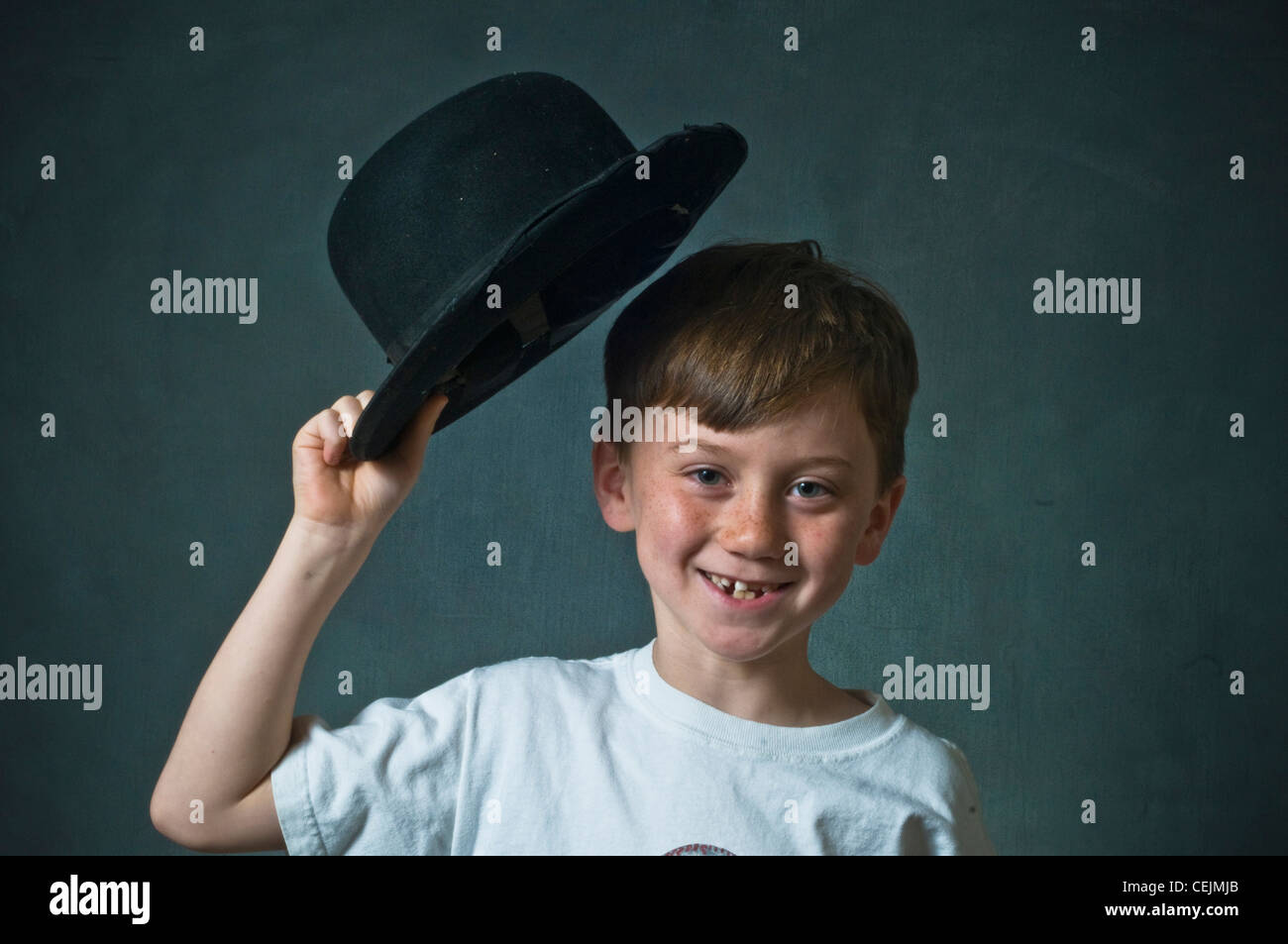 Young boy, funny face, bowler hat Stock Photo - Alamy