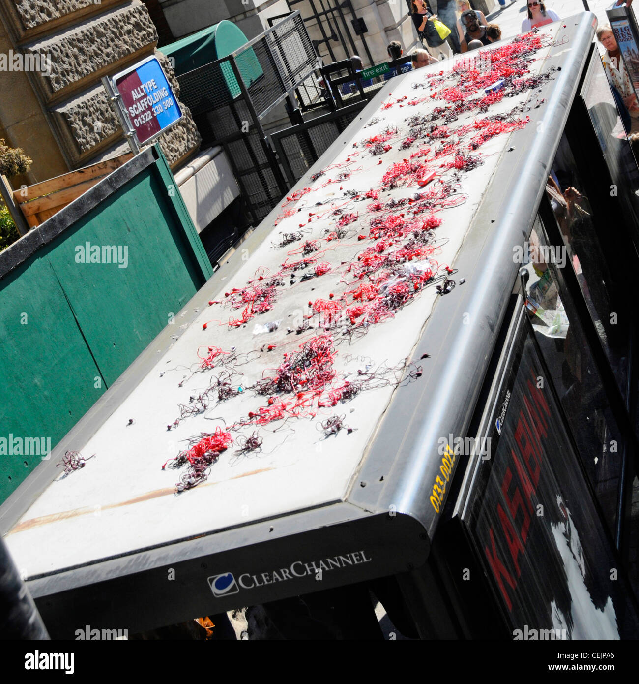 View from above looking down at tour bus stop & shelter roof littered ...