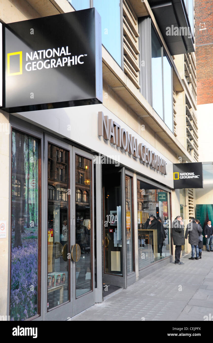 Pavement street scene with National Geographic shop front and signs ...